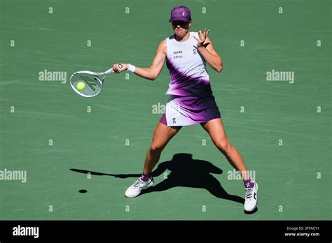 Iga Swiatek Of Poland Returns The Ball To Qinwen Zheng Of China