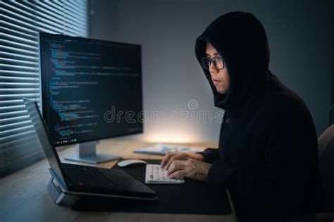 Hacker Man Wearing Hood Writing Code To Hack Network Security System