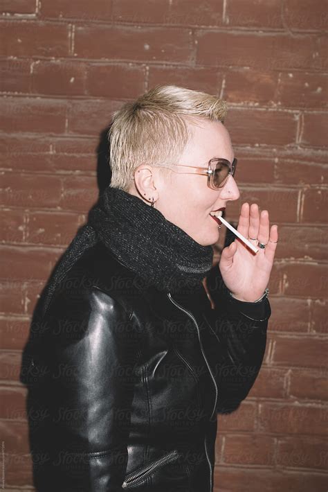 Lesbian Woman Lighting Cigarette By Stocksy Contributor Alexey Kuzma