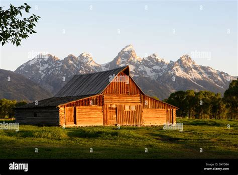 Moulton Barn At Sunrise With Rainbow On Mormon Row Against The Teton