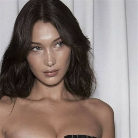 A Close Up Of A Woman Wearing A Strapless Top And Posing For The Camera