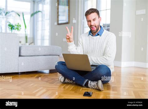 Handsome Man Wearing Working Using Computer Laptop Smiling With Happy Face Winking At The Camera