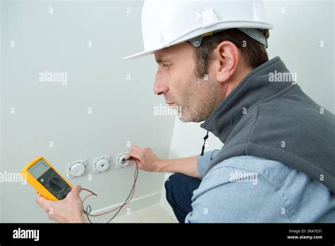 Electrician Measuring Voltage Of Socket Stock Photo Alamy