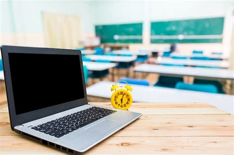 Premium Photo Computer On The Table Blur Image Of Classroom As Background