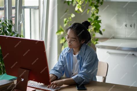 Premium Photo Focused Asian Woman It Developer Wearing Glasses Writing Code On Computer While