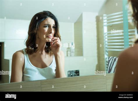 Depressed Girl Looking In Mirror