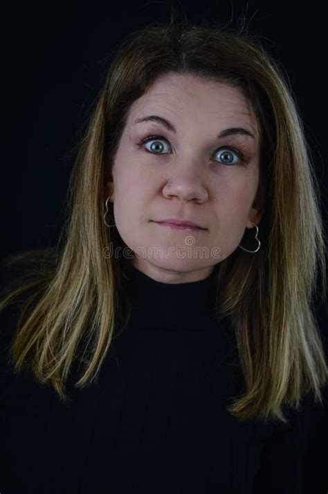 Portrait Of A Beautiful Blond Woman With Her Eyes Wide Open And A Slight Smile Stock Image