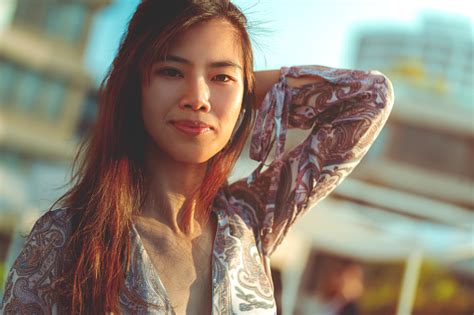 Asian Chinese Woman With Tanned Beauty Skin Portrait In A Beach Town