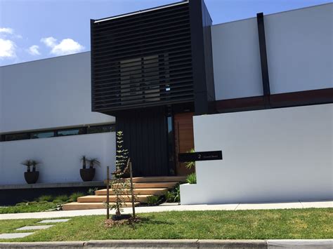 Black Metal Cladding With White Render