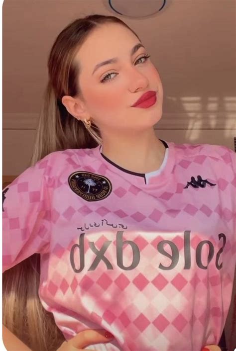 A Woman With Long Hair Wearing A Pink Shirt