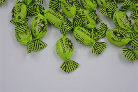 Bright Colorful Factory Menthol Candies Packed In Green Packaging With Plus Sign And Arranged