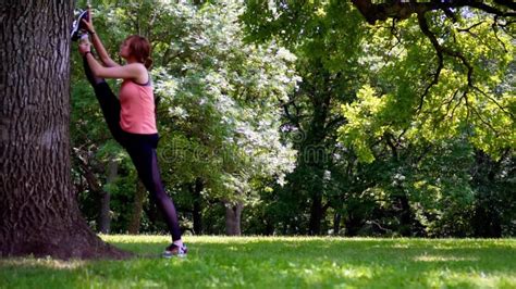 Girl Doing Twine By The Tree On The Grass In The Park Stock Video