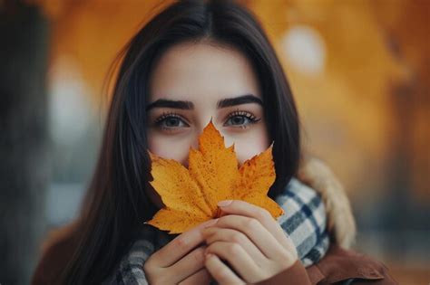 Premium Photo Portrait Of Smiling Beautiful Woman Holding Leaf