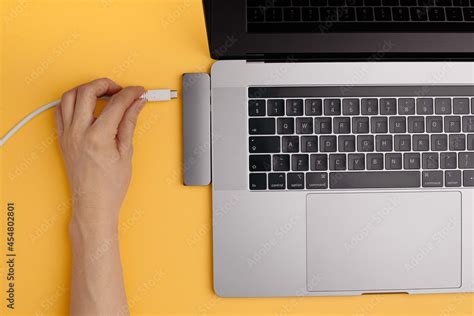Close Up Photo Of Type C Hub With Cables And Card Connected By Hand To A Laptop Stock Photo