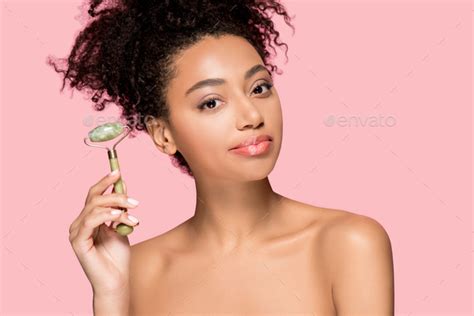 Beautiful Naked African American Girl Using Jade Roller Isolated On