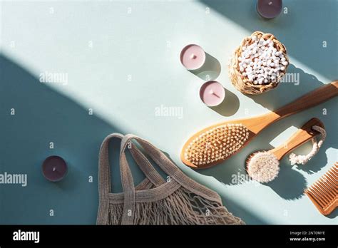 Natural Cosmetics Wooden Brushes Ear Cleaning Sticks Candles And Mesh Bag On Light Blue Table