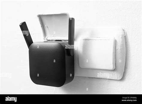 Black WiFi Repeater In Electric Socket On White Wall Stock Photo Alamy