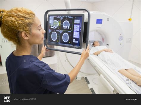 Hospital Radiographer With Female Patient Operating Ct Scanner Stock