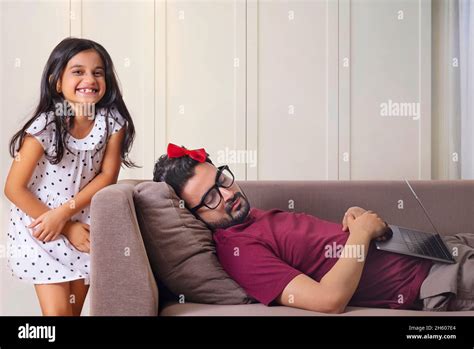 A PLAYFUL Babe LOOKING AT CAMERA WHILE TEASING SLEEPING FATHER Stock Photo Alamy