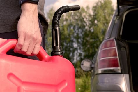 Premium Photo A Red Canister On The Asphalt Near The Car The Car Ran