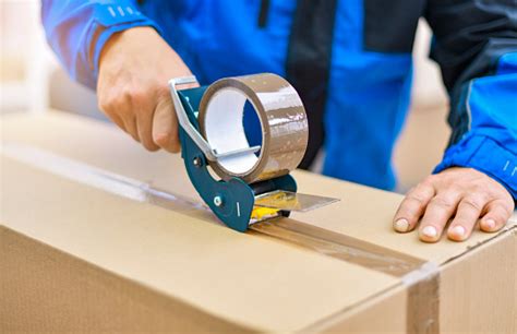 포장 기계를 들고 골판지 또는 종이 상자를 밀봉하는 작업자 손 가정의 방에 대한 스톡 사진 및 기타 이미지 가정의 방 남자