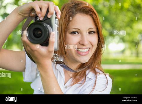 Pretty Redhead Taking A Photo In The Park Stock Photo Alamy