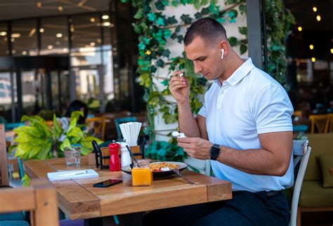 카페에 앉아있는 동안 노트북에서 일하는 젊은 잘 생긴 사업가 20 29세에 대한 스톡 사진 및 기타 이미지 20 29세 Brand Name Smart Phone