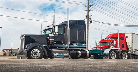 Two Semi Trucks Parked Next To Each Other