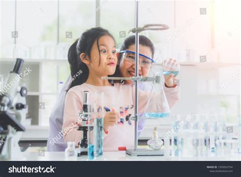 Girl Babe Holding Flask And Test Tube In Hands In Lab Learning Chemistry Experiment With
