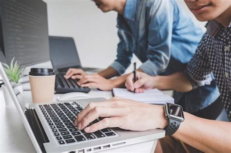 Premium Photo Midsection Of Coders Working Over Computer Program