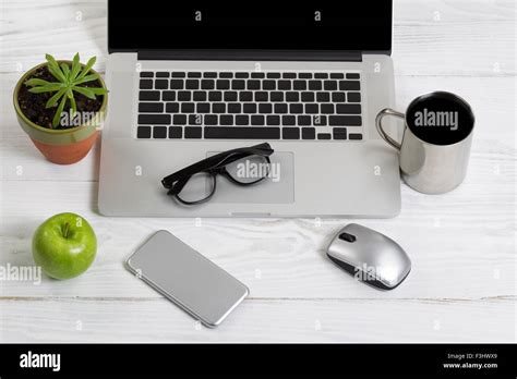 Clean And Organized White Desktop With Office Work Objects And Snacks Layout In Horizontal