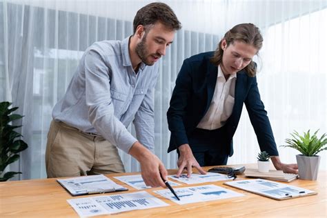 Premium Photo Analyst Team In Office Analyzing Financial Data Analysis Papers Entity