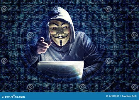 Portrait Of Hacker Man With Mask Looking Back While Typing Laptop On