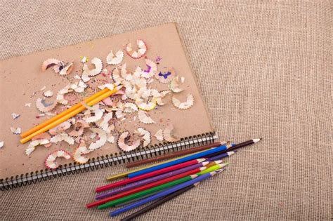Premium Photo Color Pencils Over A Notebook