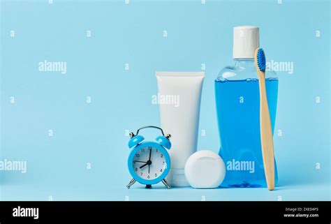 Mouthwash And Toothpaste Tube Alarm Clock On Blue Background Stock