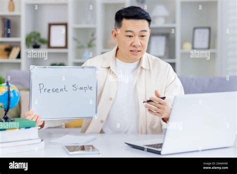 Online English Teacher Explaining Present Simple Tense During A Virtual