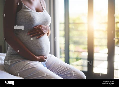 With A Growing Belly Comes A Growing Bond A Pregnant Young Woman Relaxing On The Bed At Home