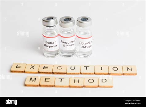 Medical Vials With A Label Reading The Names Of Lethal Injection Drugs With A Sign Reading