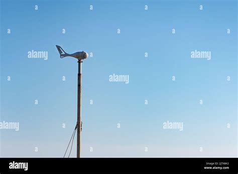 A Plane Type Anemometer On A Post Against A Blue Sky Background Stock