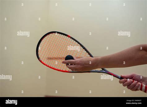 Female Hand Holding A Squash Racket And Hitting The Ball Stock Photo Alamy