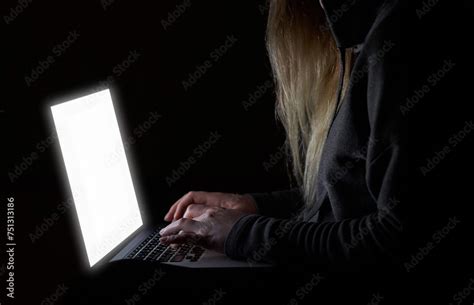 Overhead Hacker In The Hood Working With Laptop And Mobile Phone Typing Text In The Darkroom