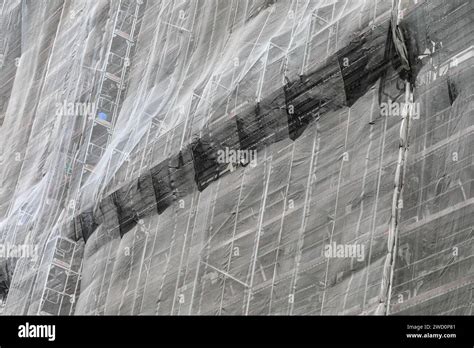Scaffolding With Safety Mesh At A Construction Site Stock Photo Alamy