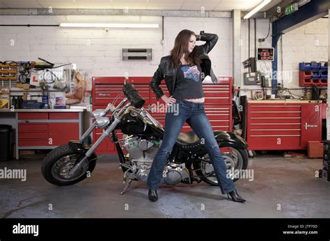 Beautiful Girl And A Custom Built Chopper Motorcycle In A Garage Workshop Stock Photo Alamy