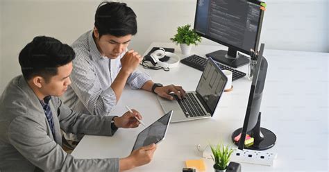 A Two Male Programer Working With Laptop And Coding On Computer Photo Place Of Work Image On