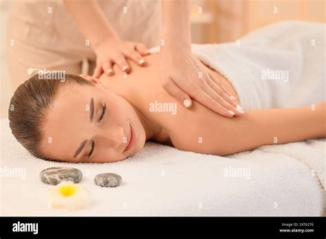 Beautiful Young Woman Undergoing Treatment By Therapist In Spa Salon