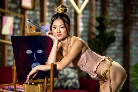 Lulu Chu Removes Her Lingerie To Exhibit Her Pussy On A Red Couch