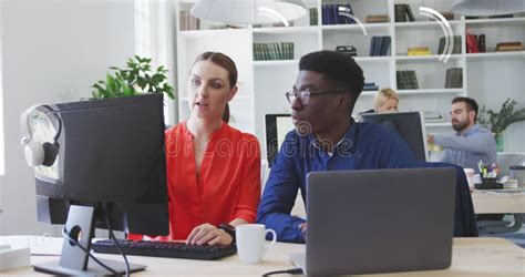 Image Of Stock Market Data Processing Against Diverse Man And Woman Discussing At Office Stock