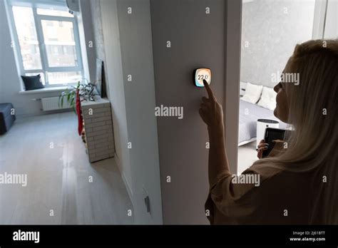 Beautiful Happy Woman Push Button Digital Thermostat At House Stock Photo Alamy