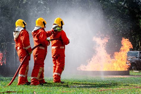 소방관 훈련 소방관은 비상 상황에서 화재 화염과 싸우는 물과 소화기를 사용하여 위험 상황에서 모든 소방관은 안전을 위해 소방관복을 입고 40 44세에 대한 스톡 사진 및