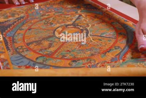 Traditional Nepalese Painting A Close Up Of A Womans Hands Unrolling A Scroll With A